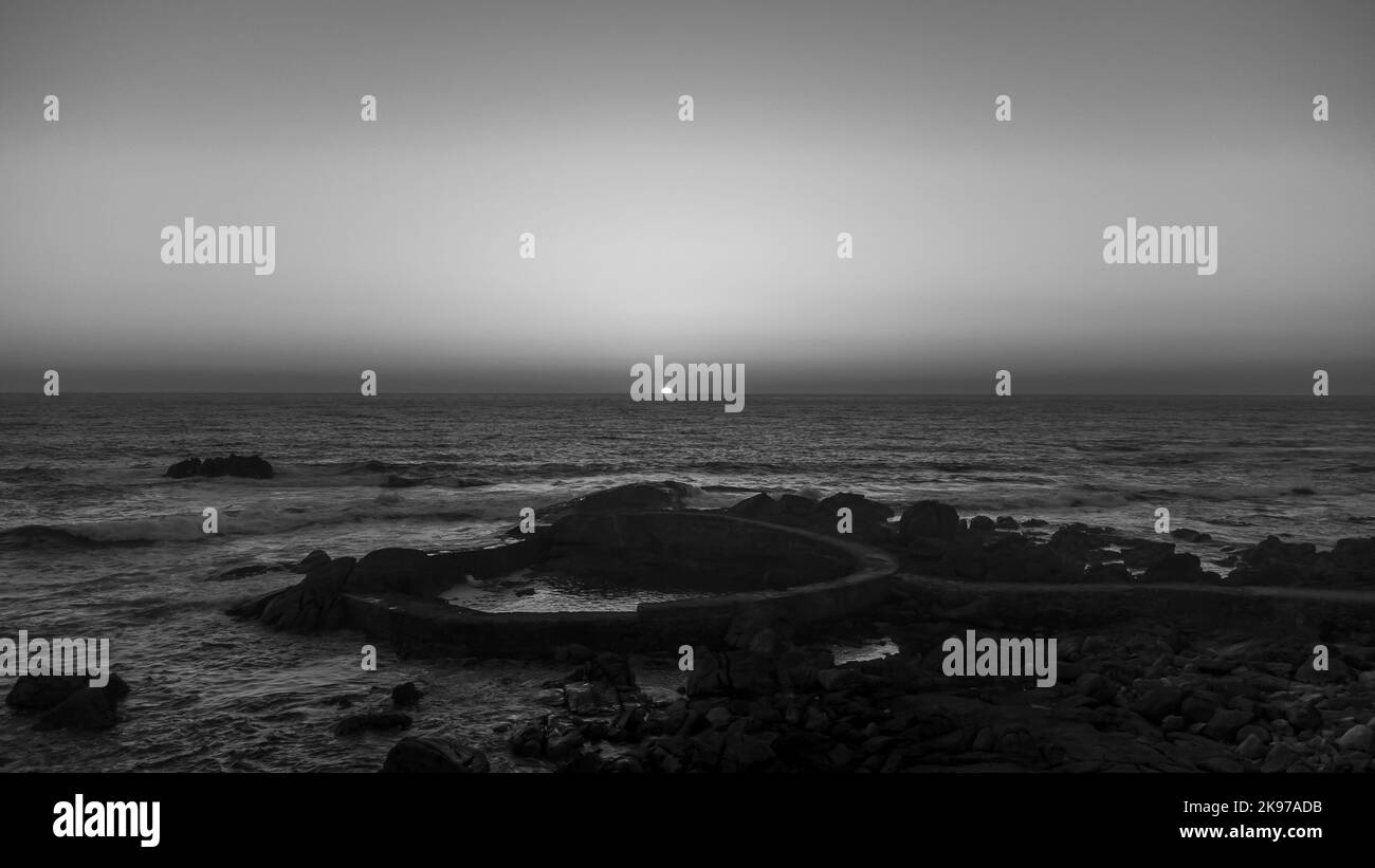 A monochrome view of the sea and hills on sunset Stock Photo - Alamy
