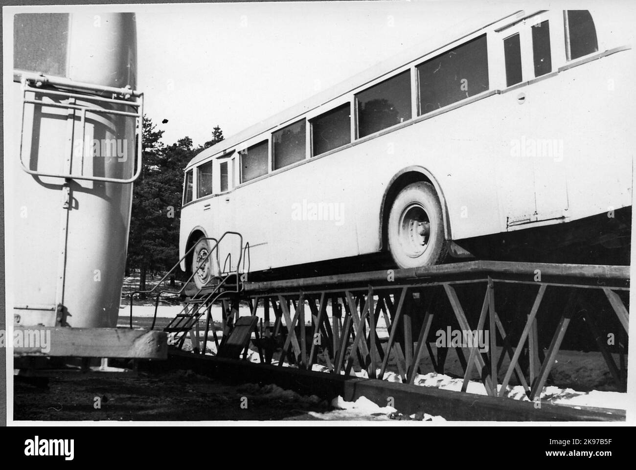 Bus driven on repair ramp Stock Photo - Alamy