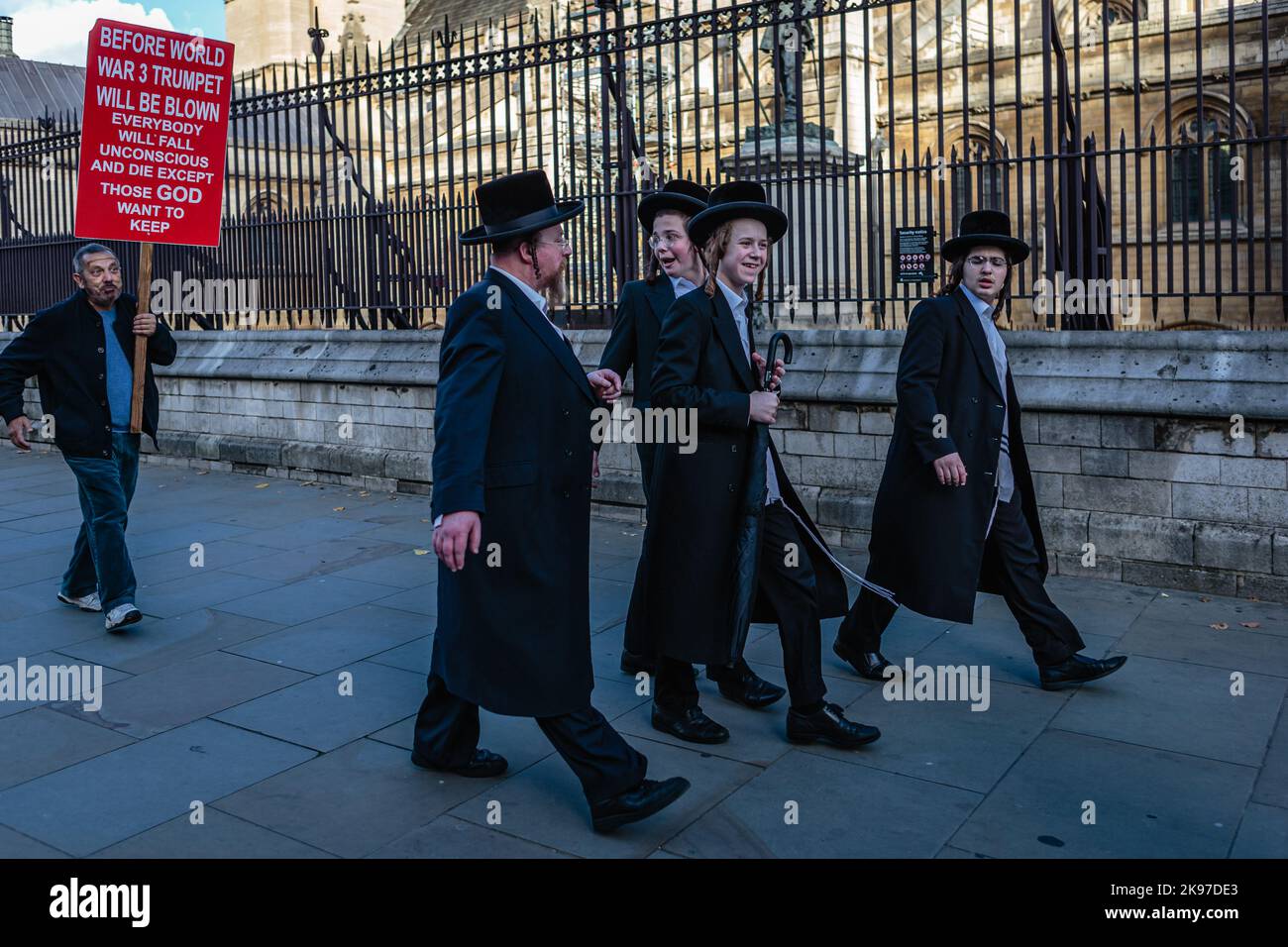 Jewish lads visit Westminster in London closely followed by a man ...