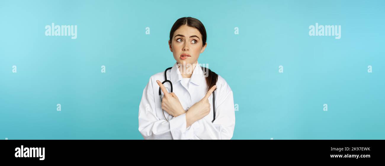 Portrait of indecisive, confused female doctor, pharmacy worker ...