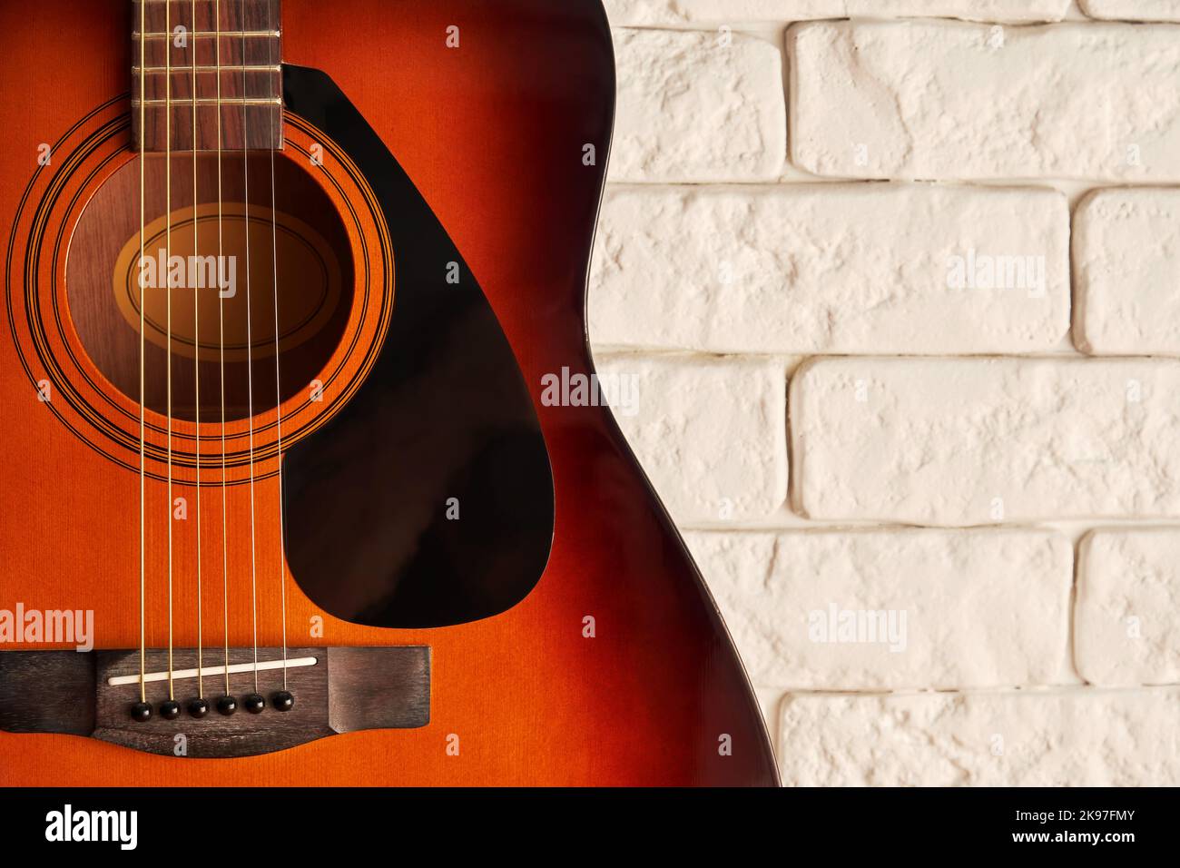 Closeup view of an acoustic guitar neck, bridge and strings near the ...