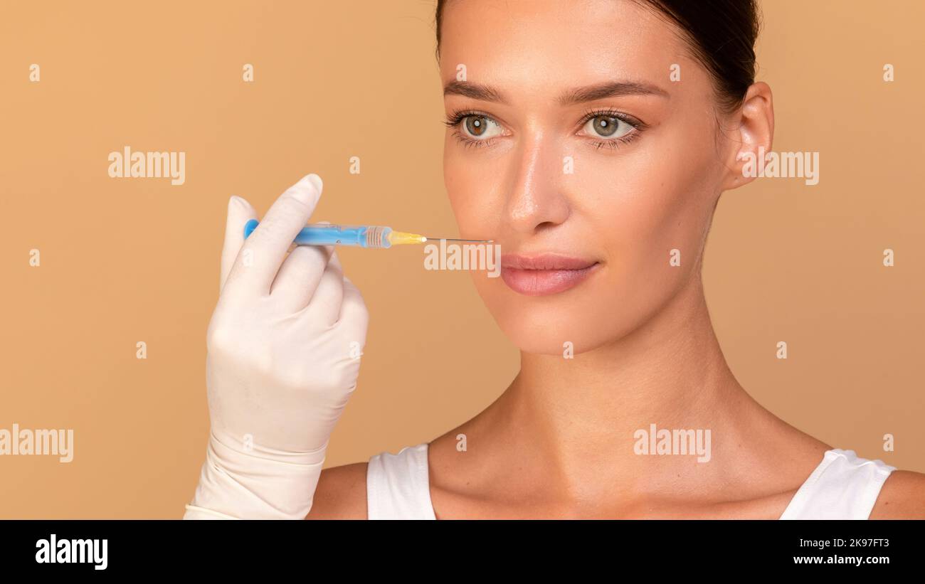 Injection cosmetology concept. Young woman getting hyaluronic acid ...