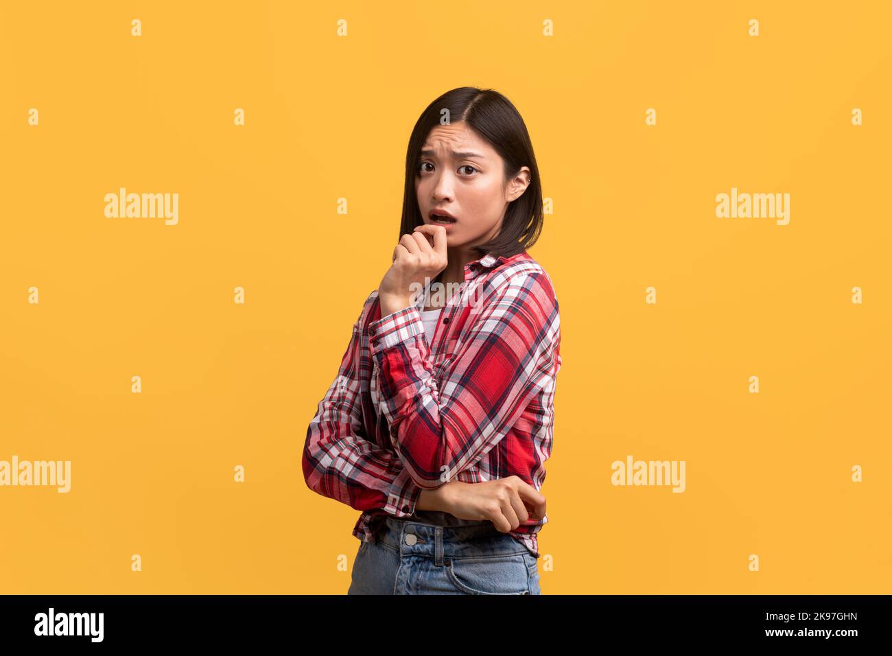 Oh no. Portrait of chinese lady touching mouth with hand and looking at ...