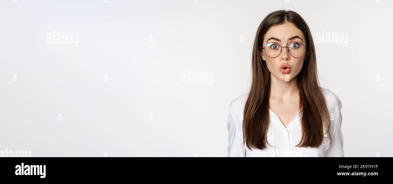 Close up portrait of corporate woman in glasses, looking surprised ...