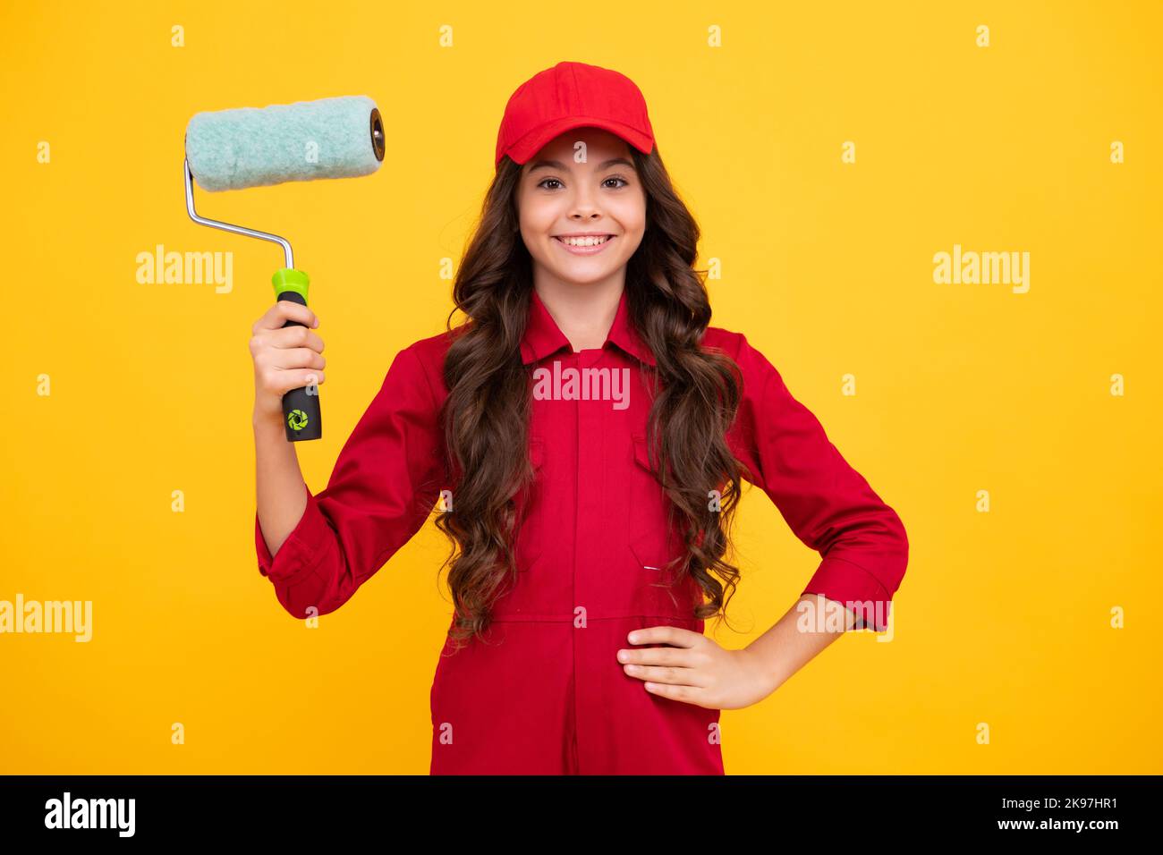 Positive and smiling builder in building uniform and cap. Painter ...