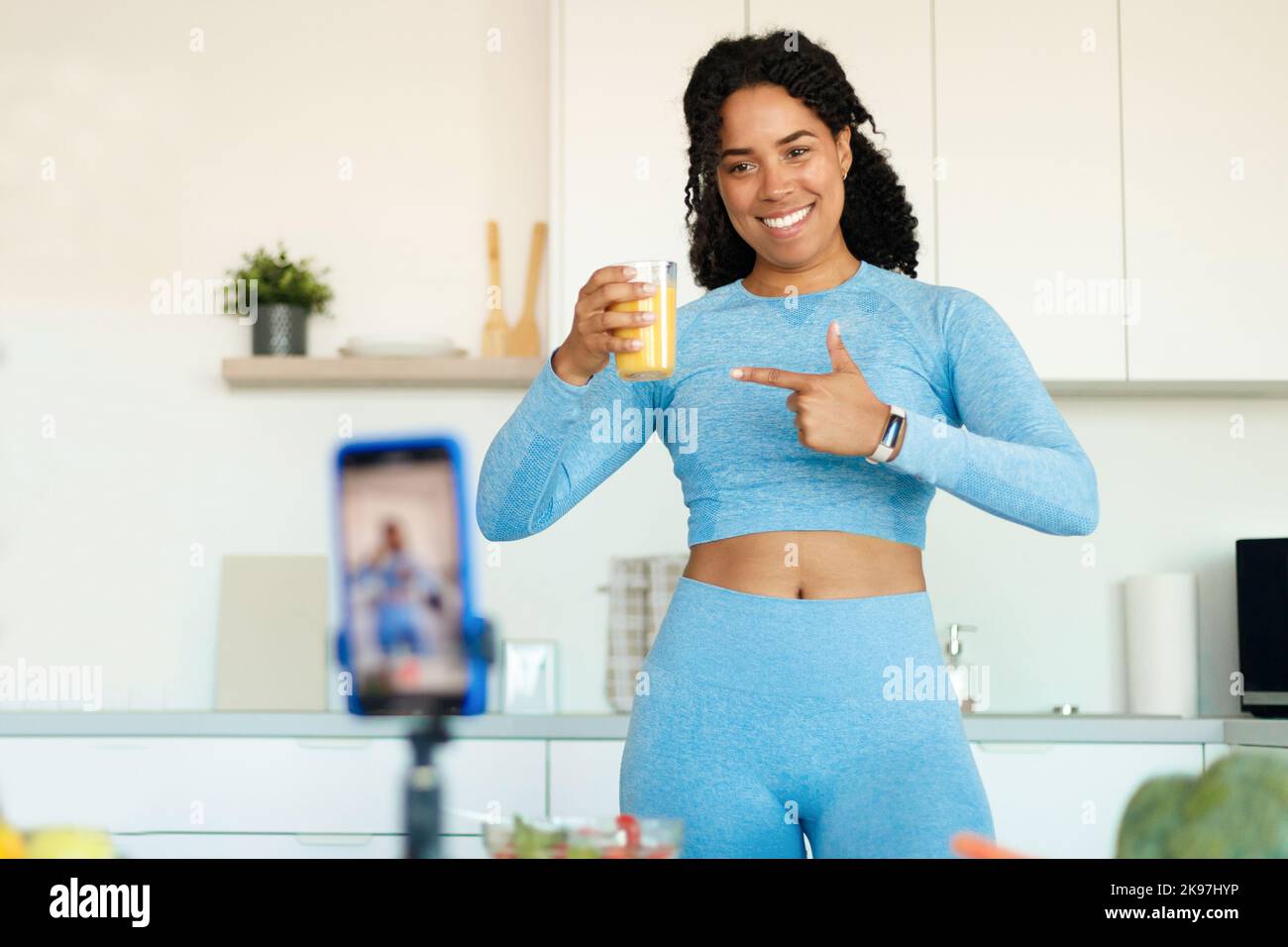 Sporty african american lady filming vlog about dieting and eating ...