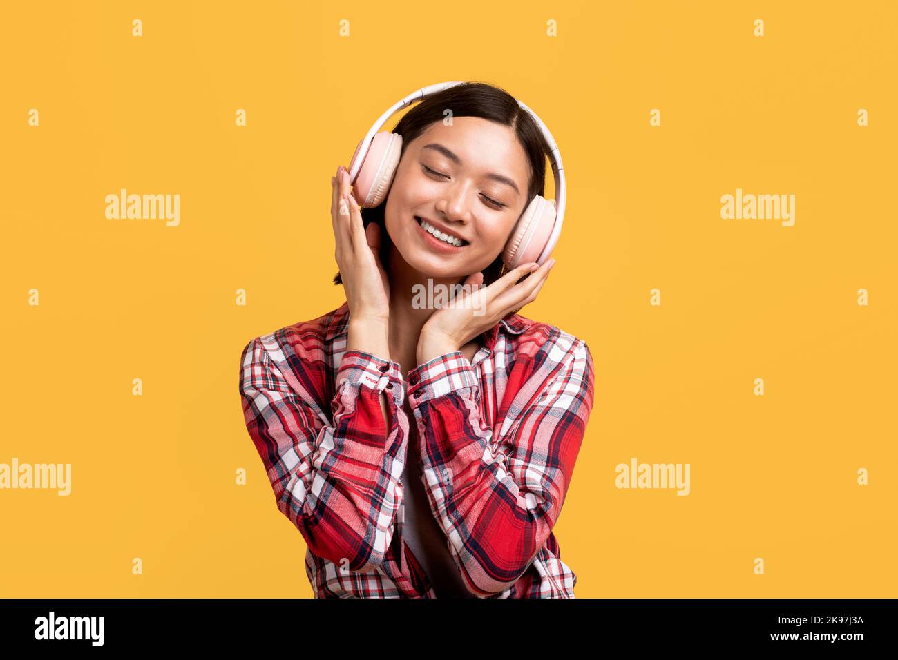 Rest and relax concept. Positive chinese lady wearing and touching ...