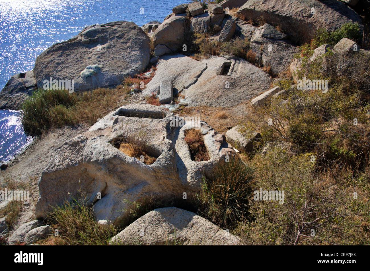 Landscape around Lake Bafa in Turkey, with ancient tombs near the water ...
