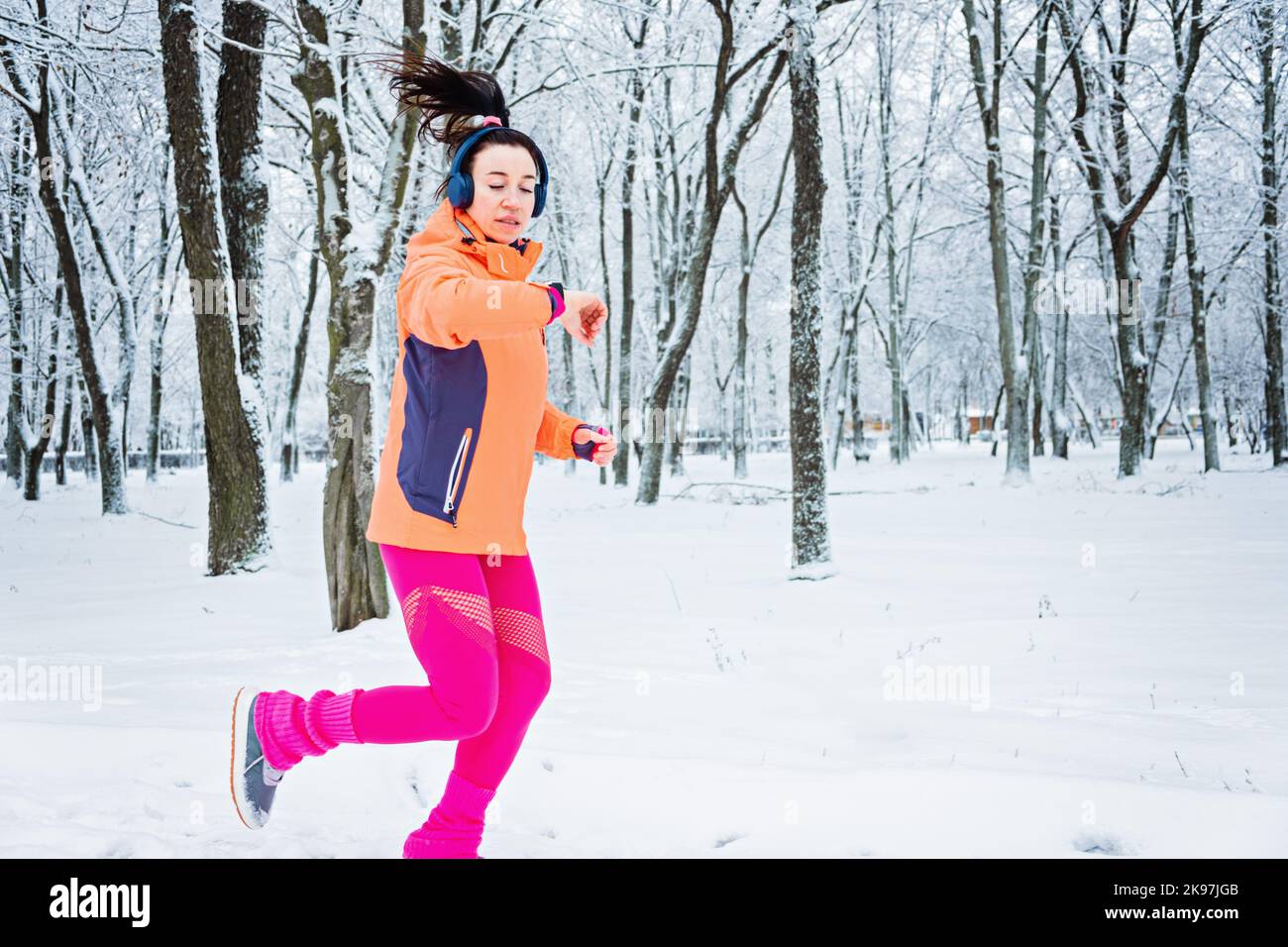 Running woman looking at smartwatch, checking heartrate and pulse ...