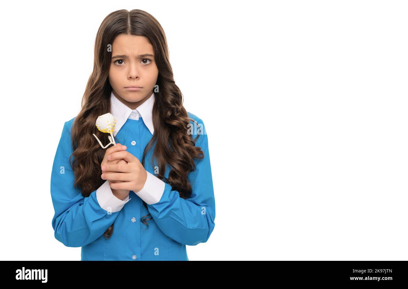 sad child with chocolate. kid with long curly hair hold stick sweet ...