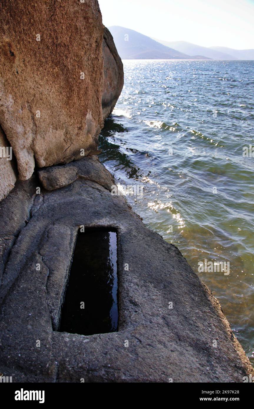Landscape around Lake Bafa in Turkey, with ancient tombs near the water ...