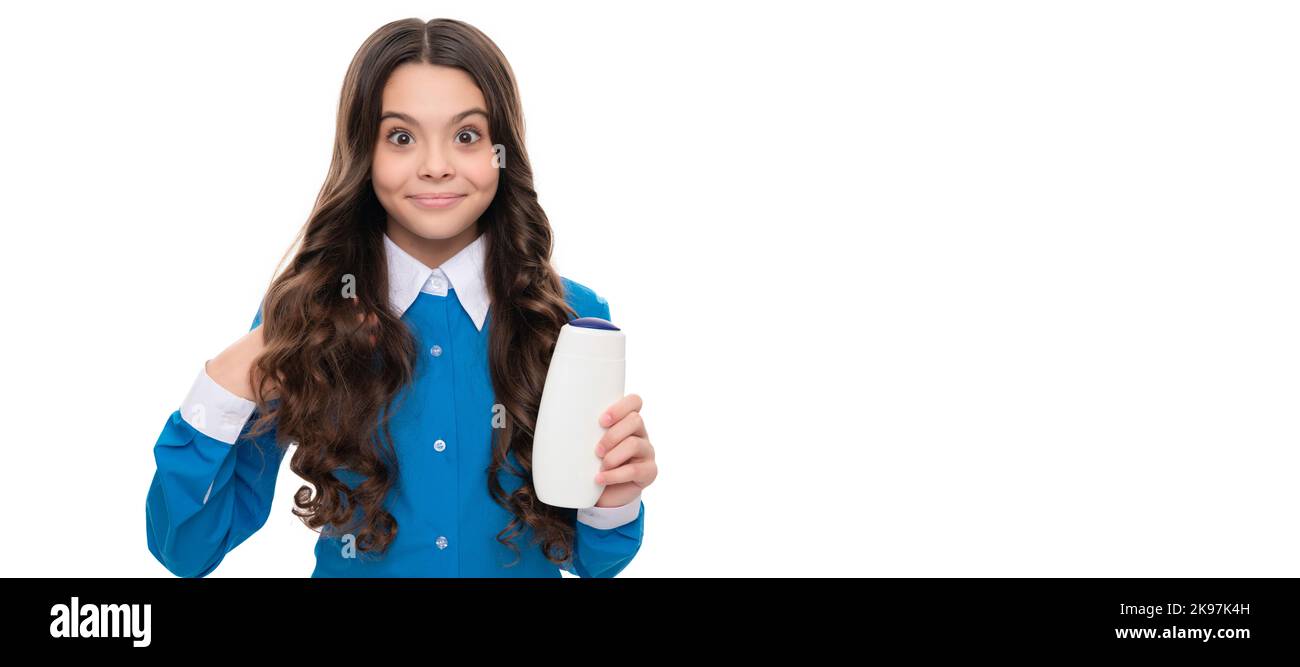 happy face of teen girl with long curly hair presenting shampoo ...