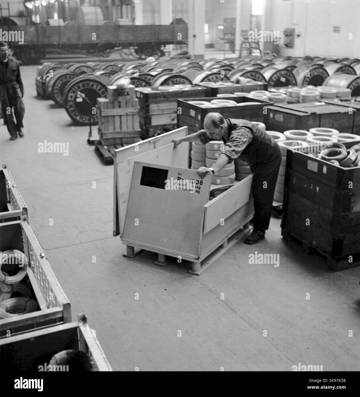 Packing of small containers, Liljeholmens cable plant Stock Photo - Alamy