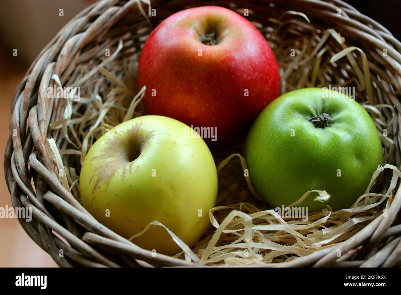 Yellow, Red And Green Apple Fruits In Wood Swarf In A Wicker Pot ...