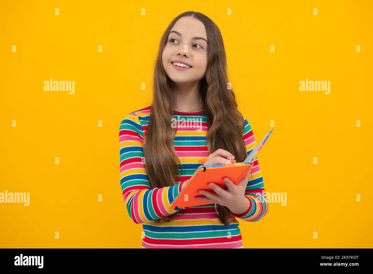 Teen girl pupil hold books, notebooks, isolated on yellow background ...