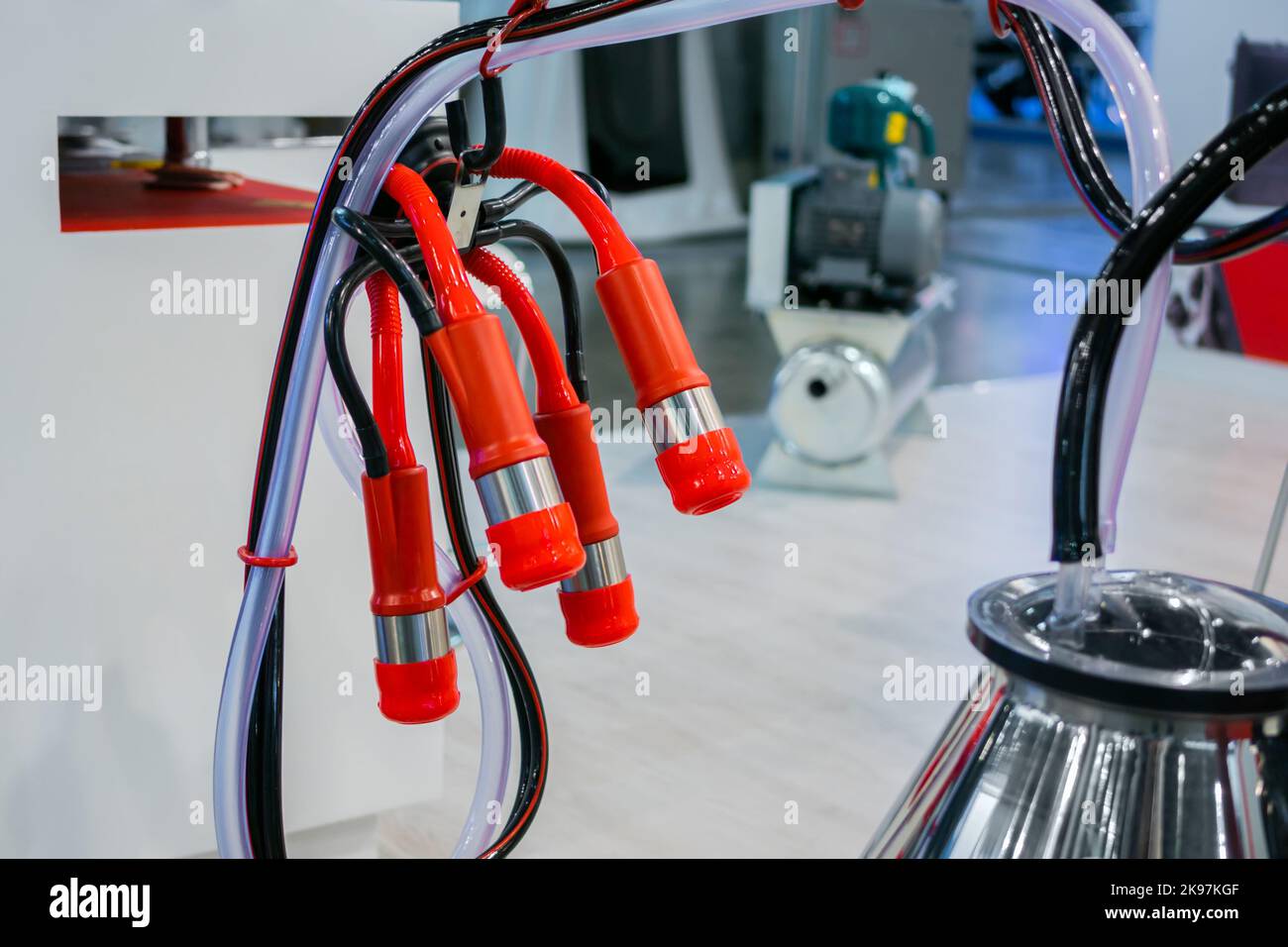 Teat cups of automated cow milking suction machine Stock Photo - Alamy