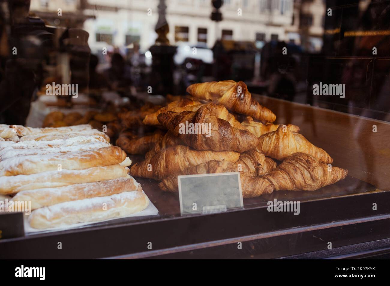 Modern bakery with different kinds of bread, cakes and buns.Warm croissants and rolls with fresh ...