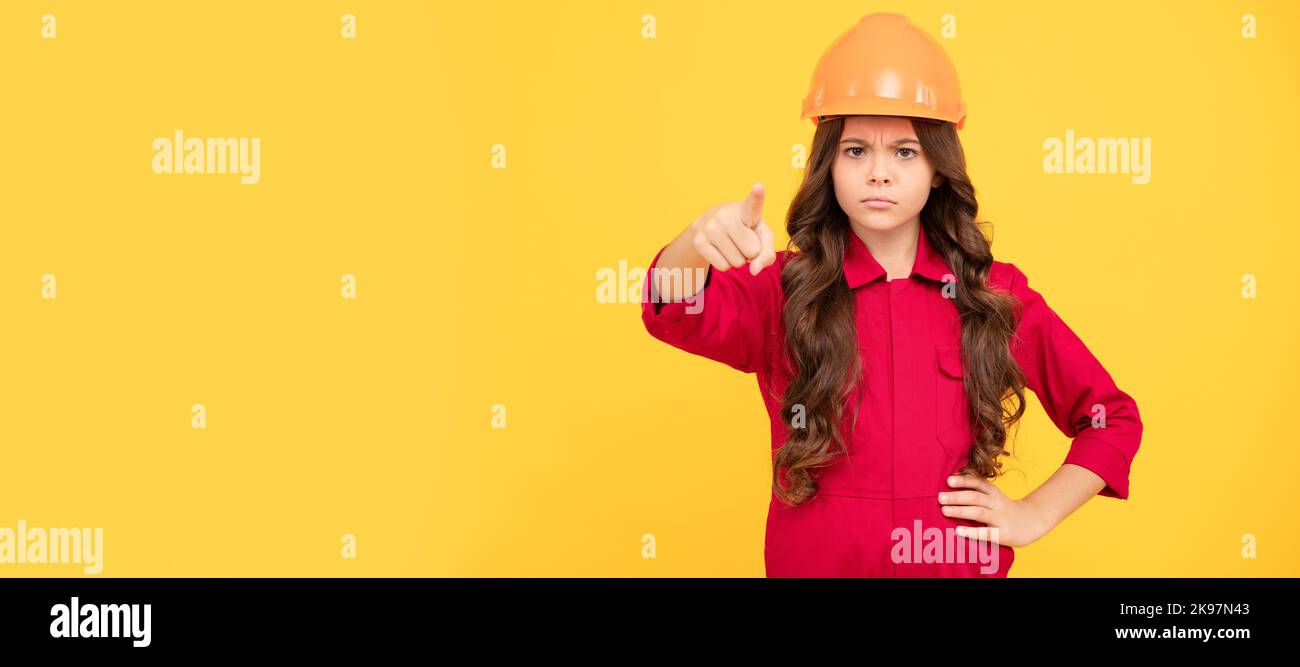 teen girl pointing finger. child in protective helmet for building ...