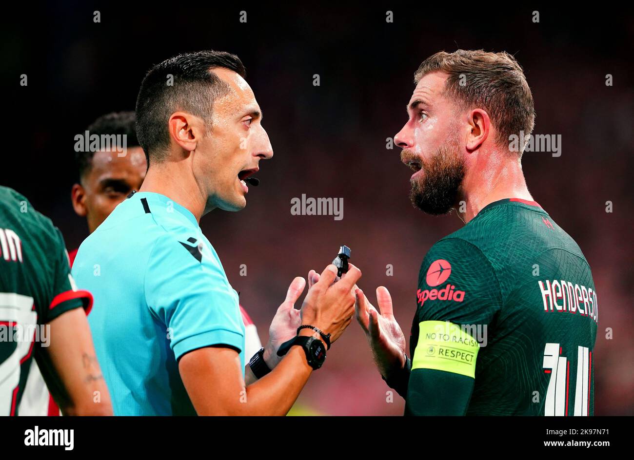 Liverpool's Jordan Henderson (right) speaks to referee Jose Maria ...