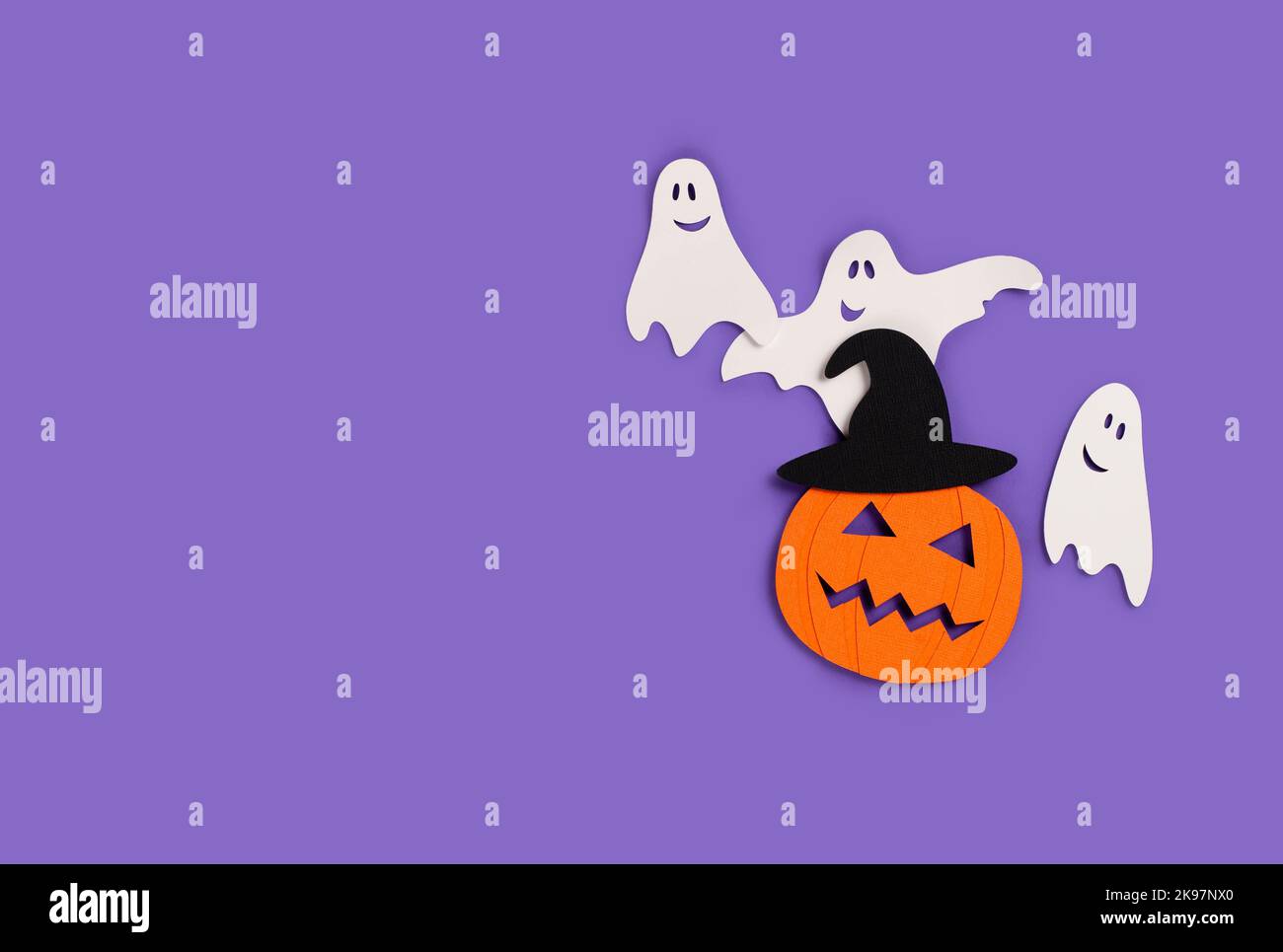 Halloween banner with paper pumpkin and ghosts on purple background ...