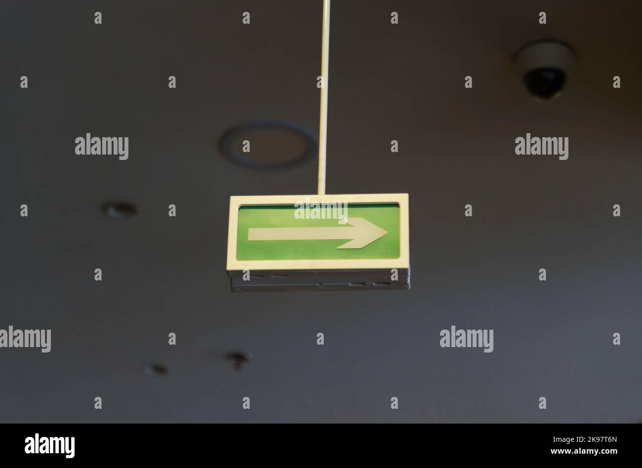 Glowing board, emergency exit sign in the building. Security concept ...