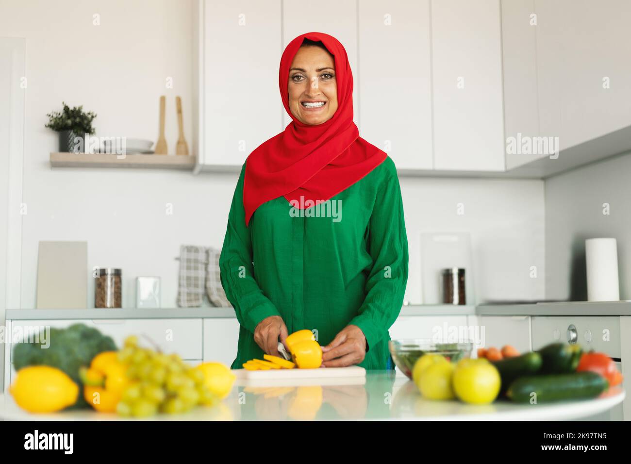 Happy Mature Muslim Woman Cooking Making Salad In Kitchen Stock Photo ...
