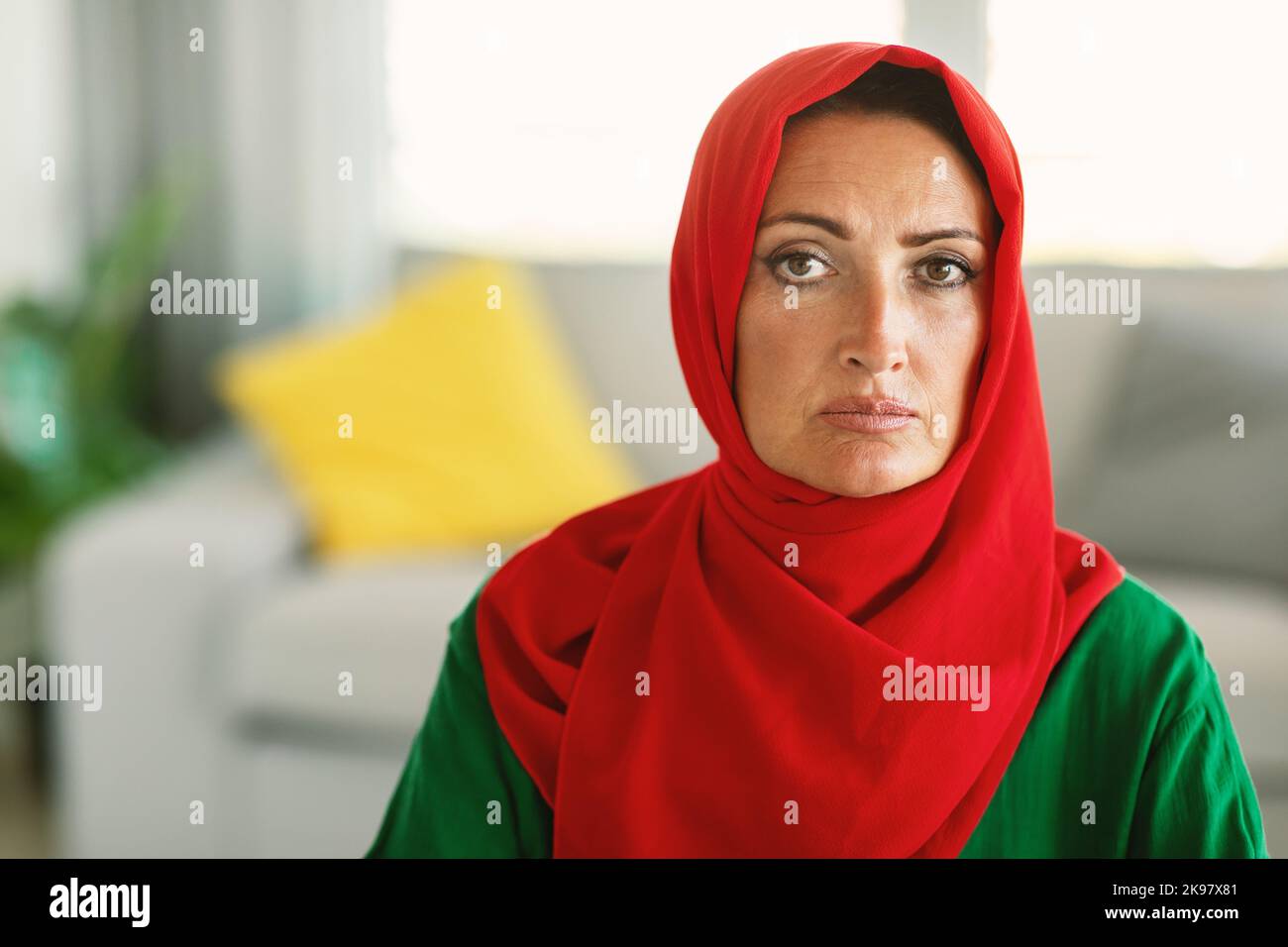 Serious Mature Muslim Lady Wearing Red Hijab Posing At Home Stock Photo ...