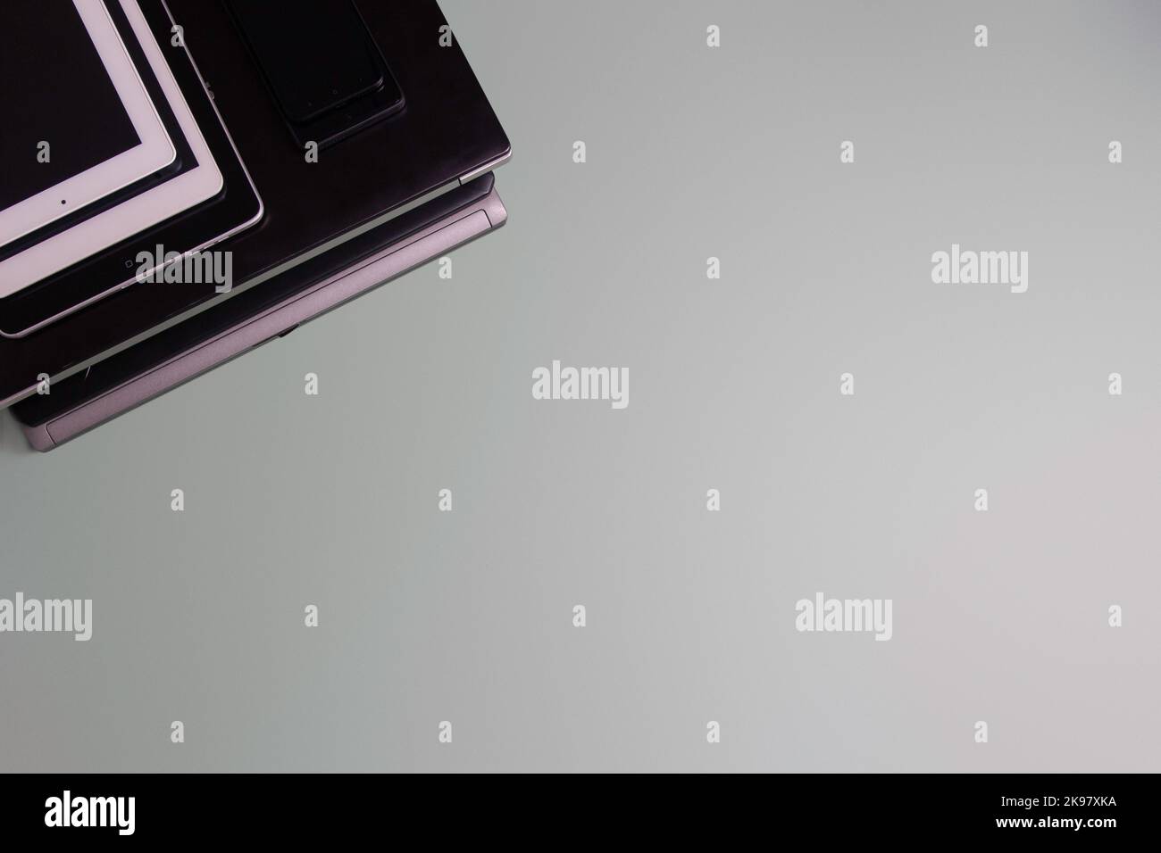 Pile of old used laptop computers, digital tablets, smartphones on gray ...