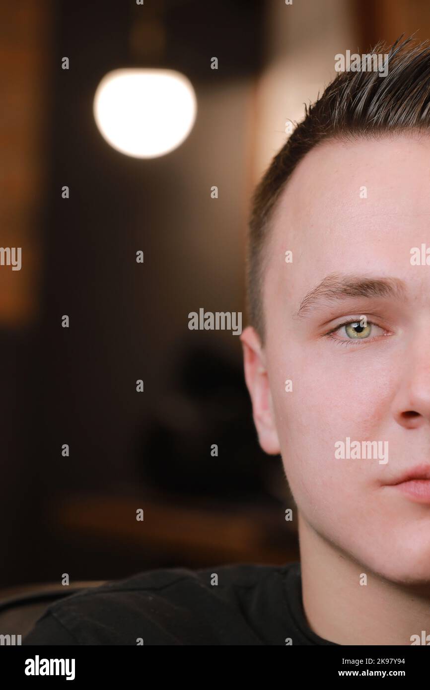 half face portrait of serious concentrated confident handsome young ...