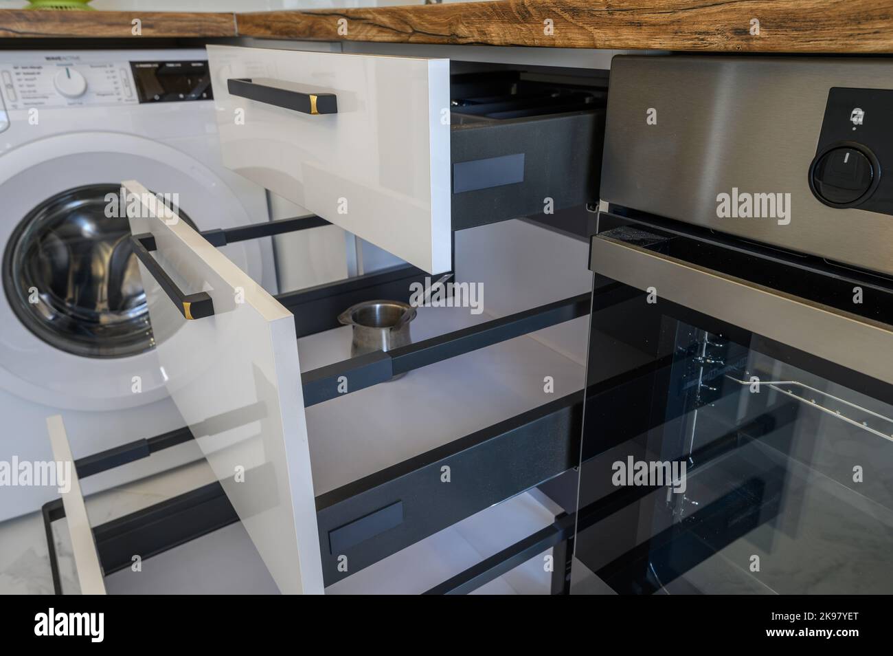 White and wooden modern kitchen furniture, some drawers open Stock ...