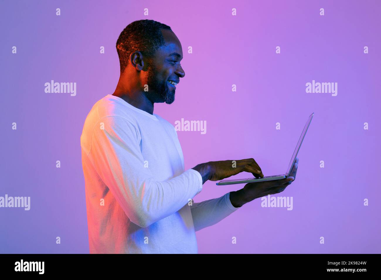 Mature african man typing hi-res stock photography and images - Alamy
