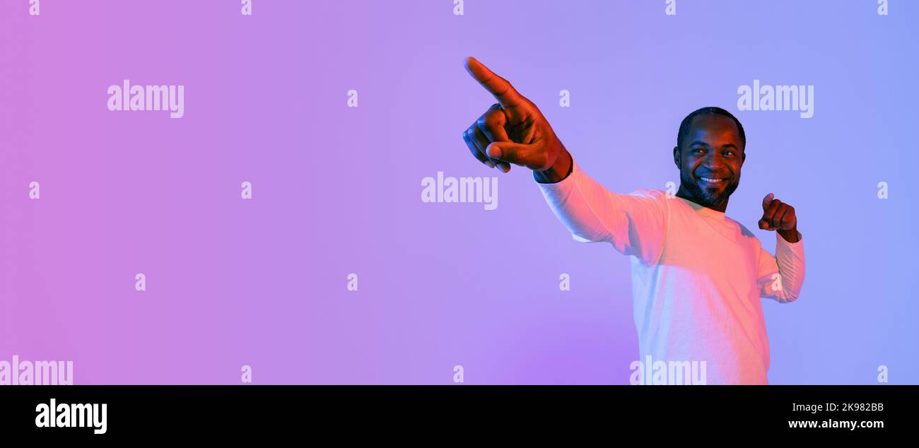 Cheerful handsome african american man pointing at copy space Stock ...