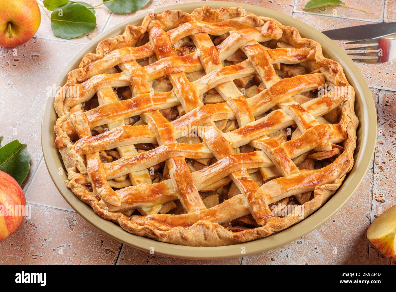Homemade Apple Pie with fresh red apple and leaves on beige travertine ...