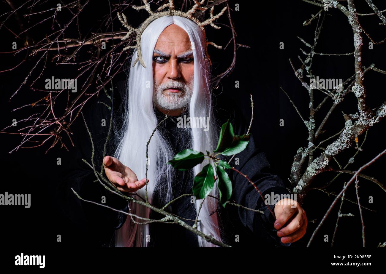 Devil man on Halloween night. Bearded male in witcher costume. Sinister ...