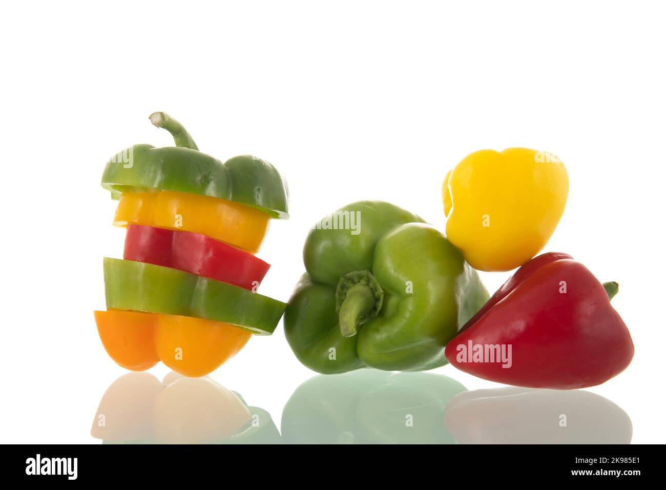 Fresh paprika in slices in different colors isolated over white ...