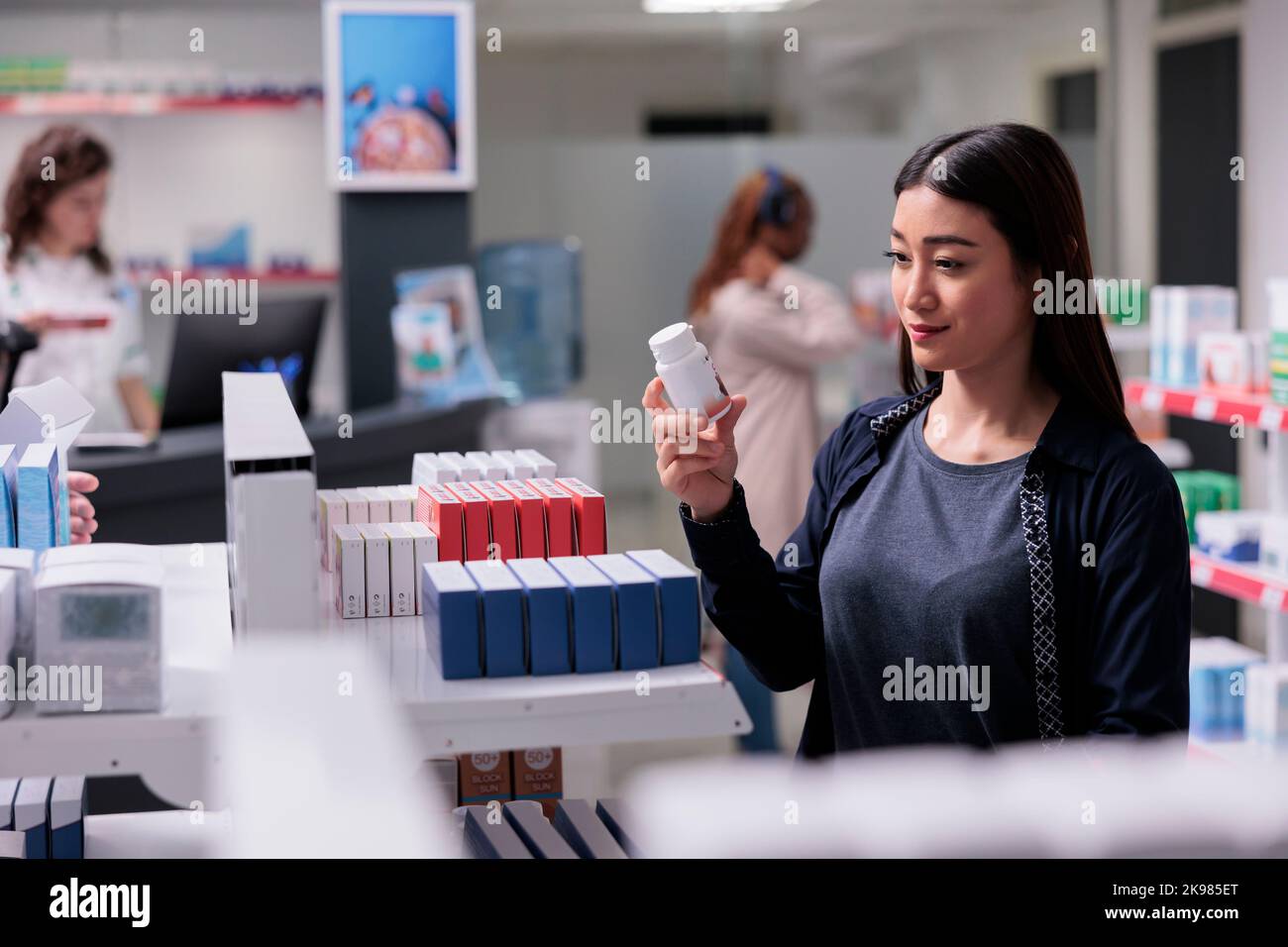 Woman client holding drugs bottle looking at pharmaceutical ...