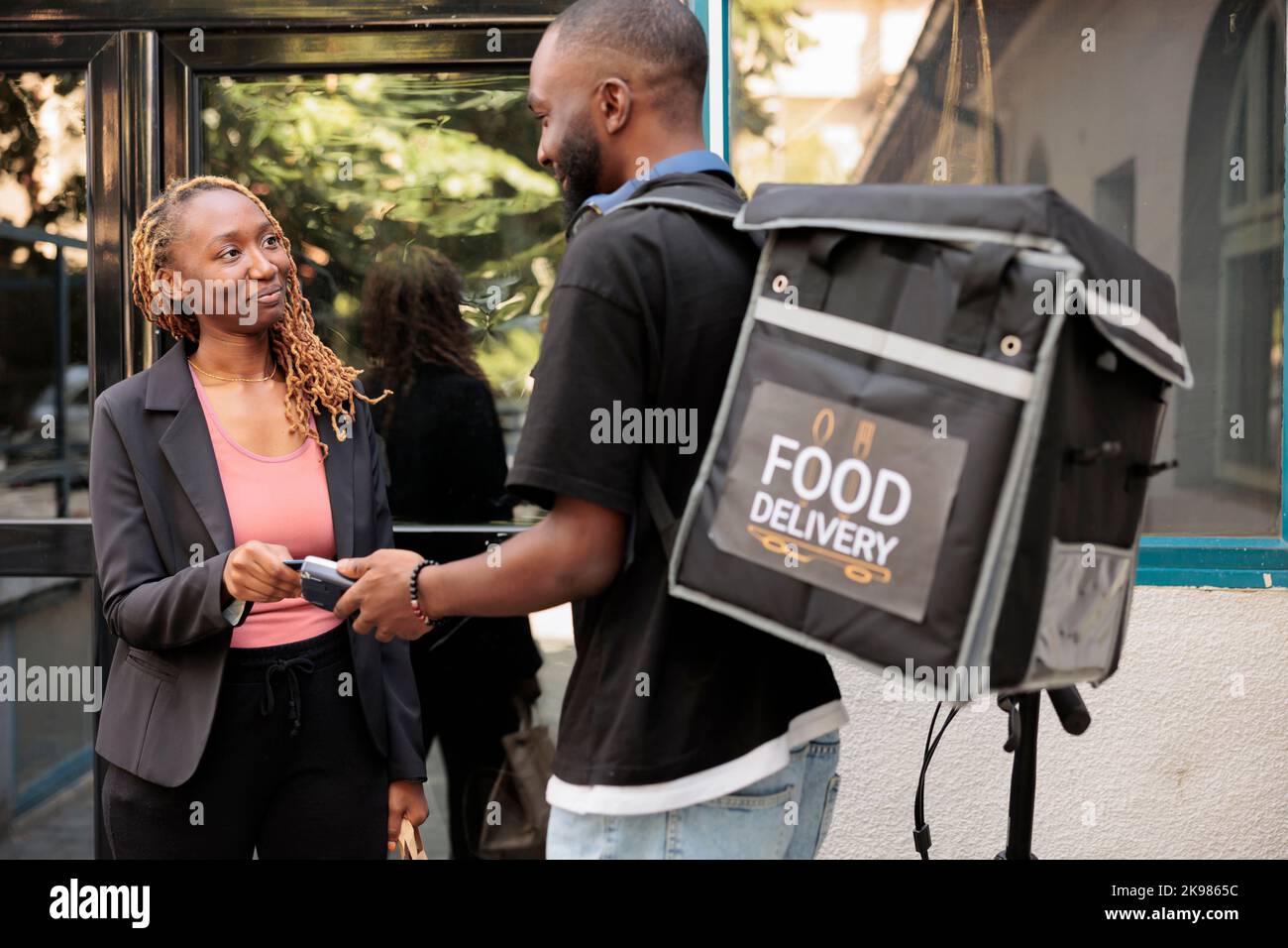 Pos terminal contactless payment for food order delivery, woman paying ...
