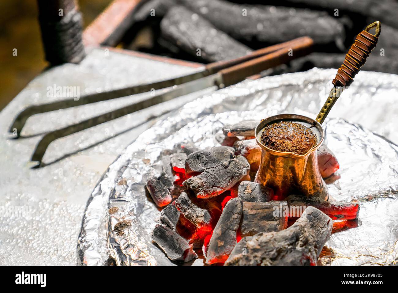 Cooking Turkish coffee on coals in traditional way. Close-up Stock ...