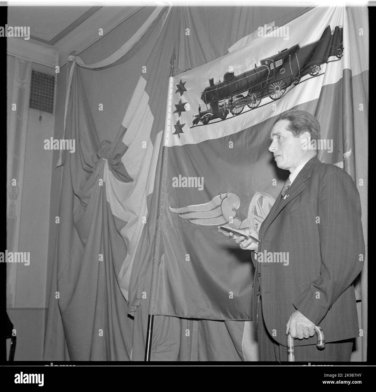 A man in front of the state's railways, SJ's flag Stock Photo - Alamy