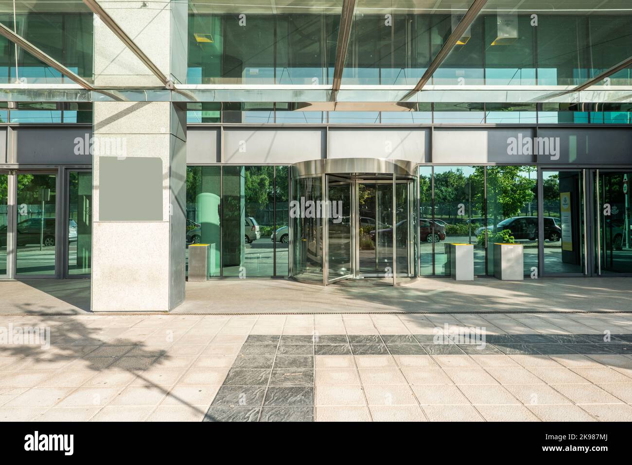 Revolving entrance of a glass and steel office building Stock Photo - Alamy