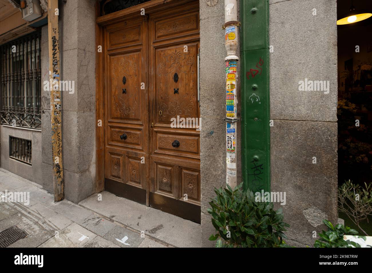 Facade of an old urban house with wooden gate and granite construction ...