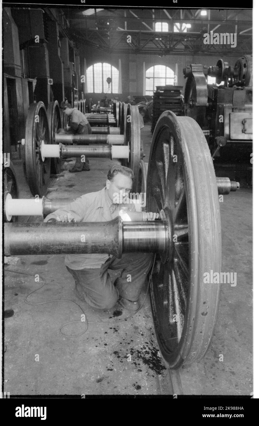 Workshop workers control the wheel axle on the wheel pair Stock Photo ...