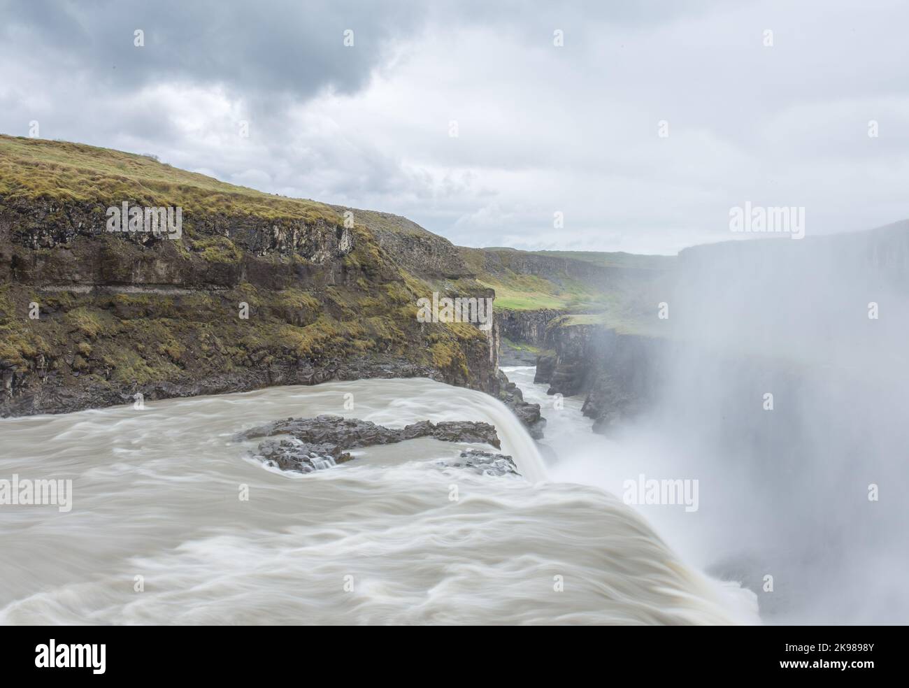Water thunders over the edge of Iceland's famous Gullfoss waterfall as ...
