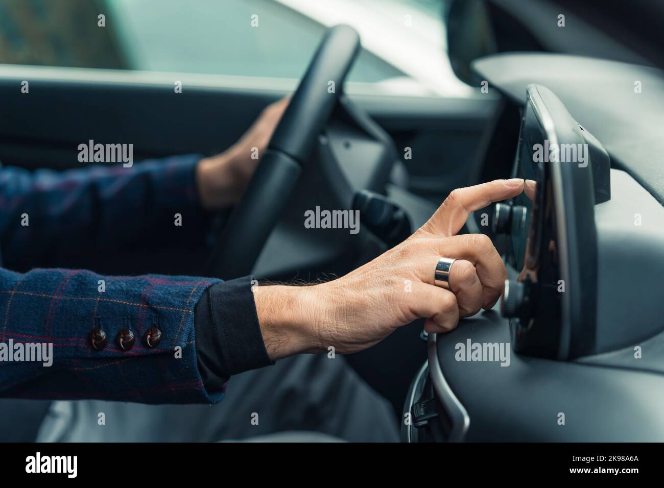 Mans hands on the steering wheel of a modern car. A man holding a ...