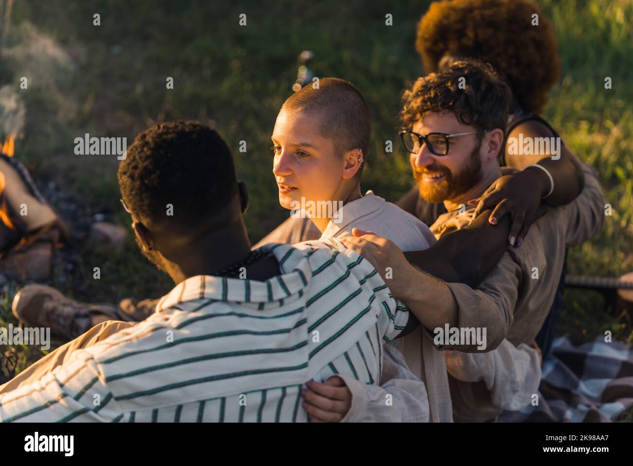 Back closeup shot of four people - two Caucasian, and two Black ...