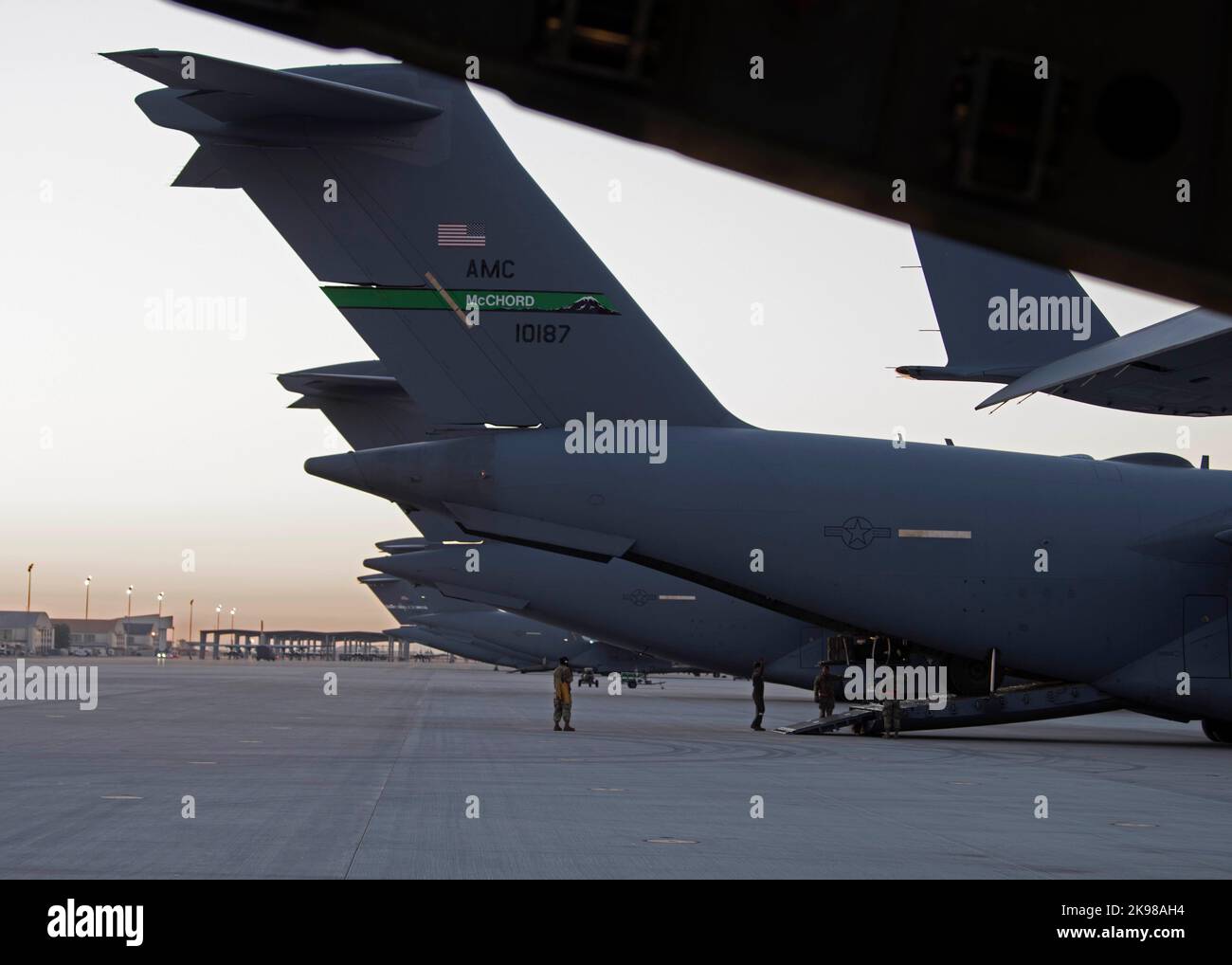 U.S. Airmen with the 62d Airlift Wing load a forklift onto a C-17 ...