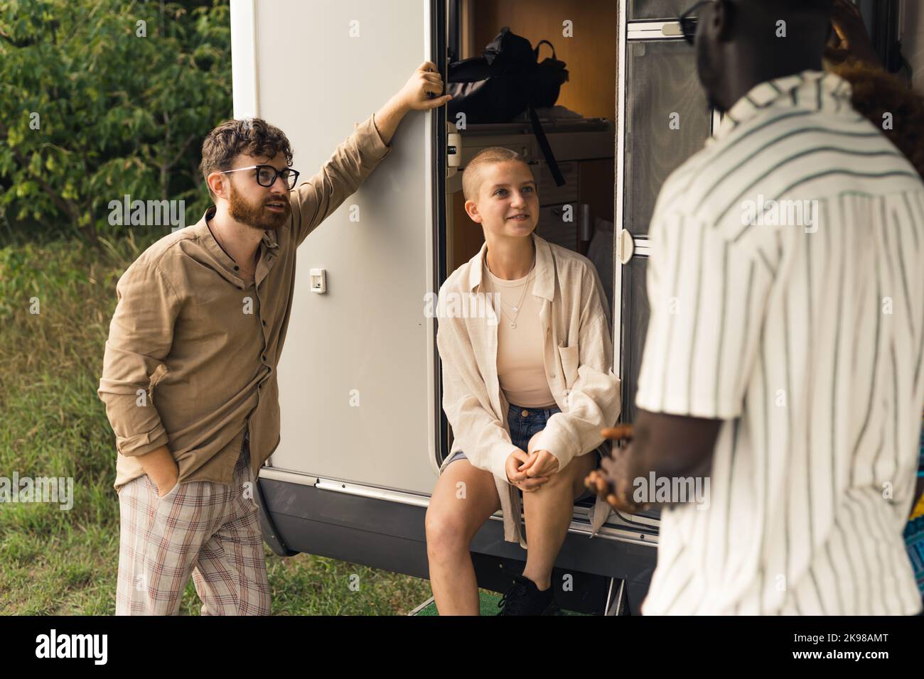 Ethnically diverse group of friends in their 20s or 30s standing in ...