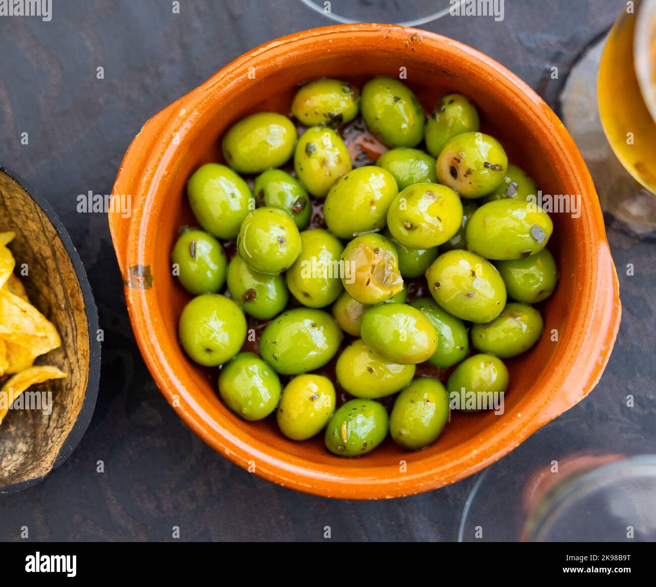 Typical spanish tapas is green pickled olives with pits Stock Photo - Alamy