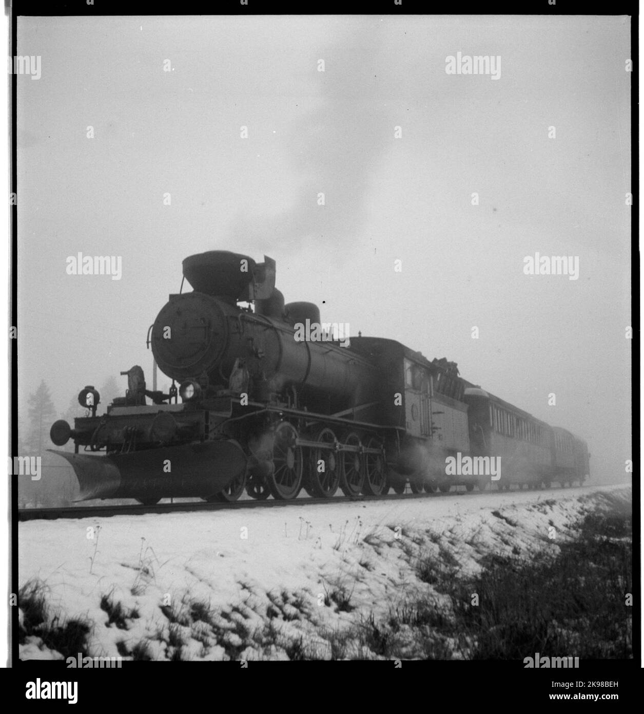 Passenger trains drawn by steam locomotive with wood burning Stock ...
