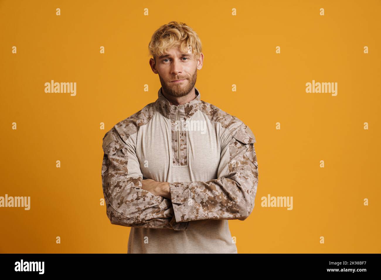 European military man wearing uniform posing with arms crossed isolated ...